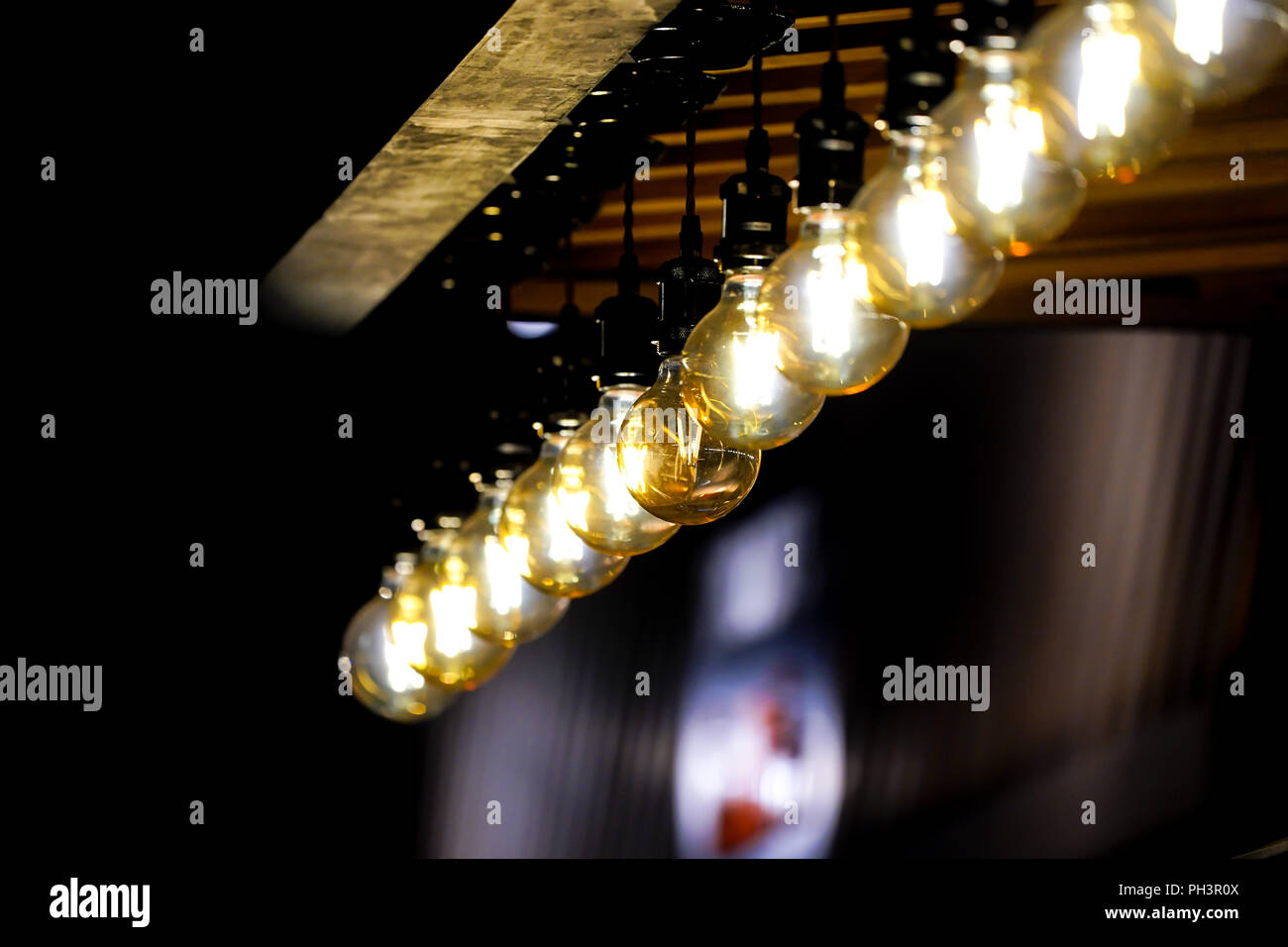 Tungsten circle lamp light on the row, stick on the wood kiosk ceiling ...