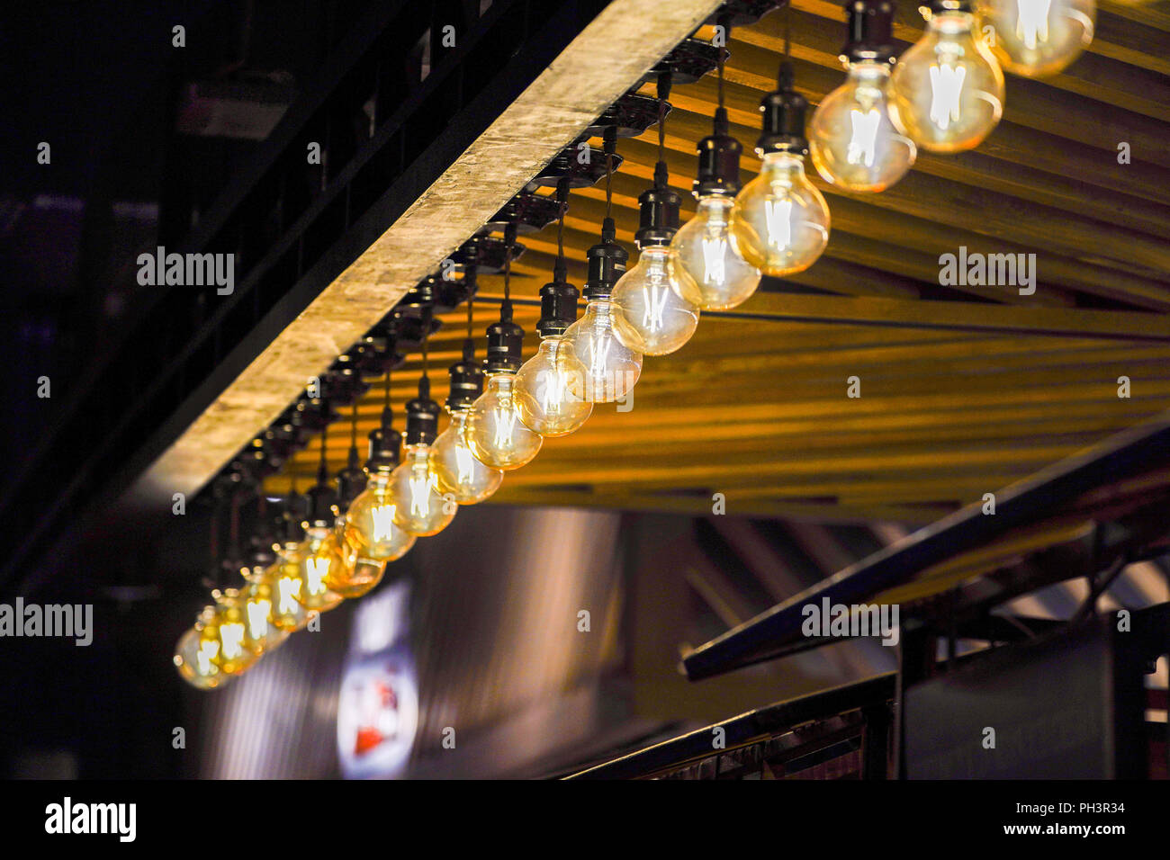 Tungsten circle lamp light on the row, stick on the wood kiosk ceiling ...