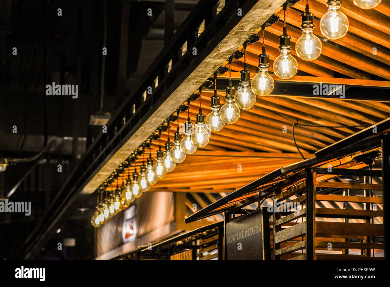 Tungsten circle lamp light on the row, stick on the wood kiosk ceiling ...