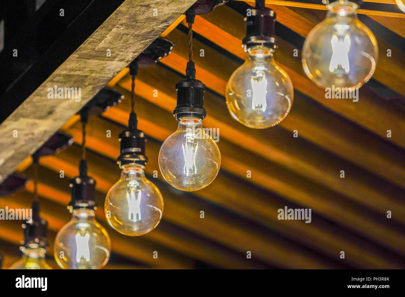 Tungsten circle lamp light on the row, stick on the wood kiosk ceiling ...