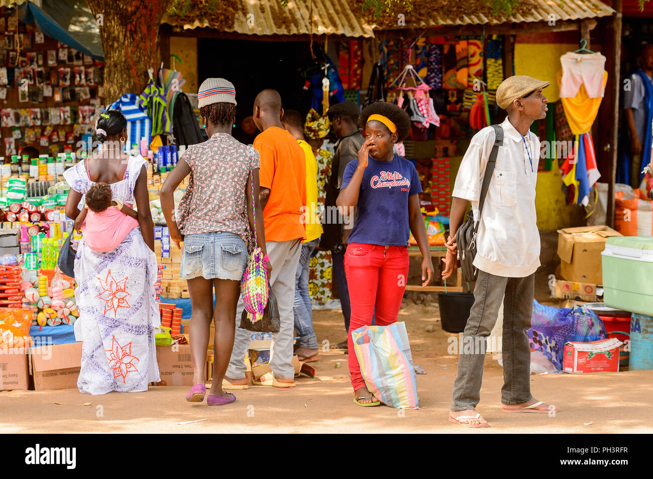 ROAD TO BISSAU, GUINEA B. - MAY 1, 2017: Unidentified local people walk ...