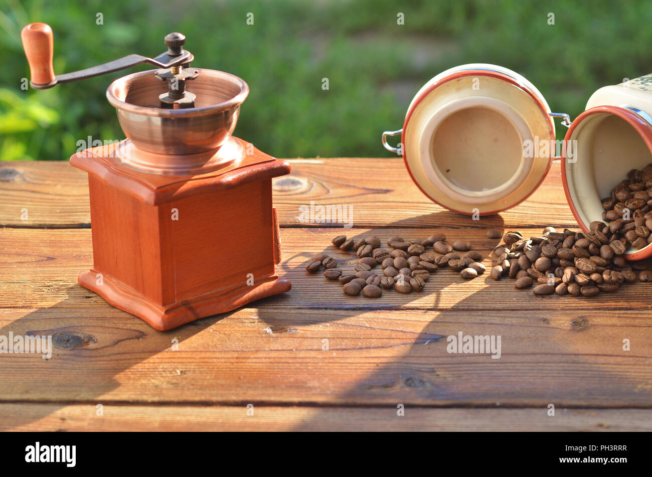 Clay pot, which pours out grains and a handmade coffee grindle on ...