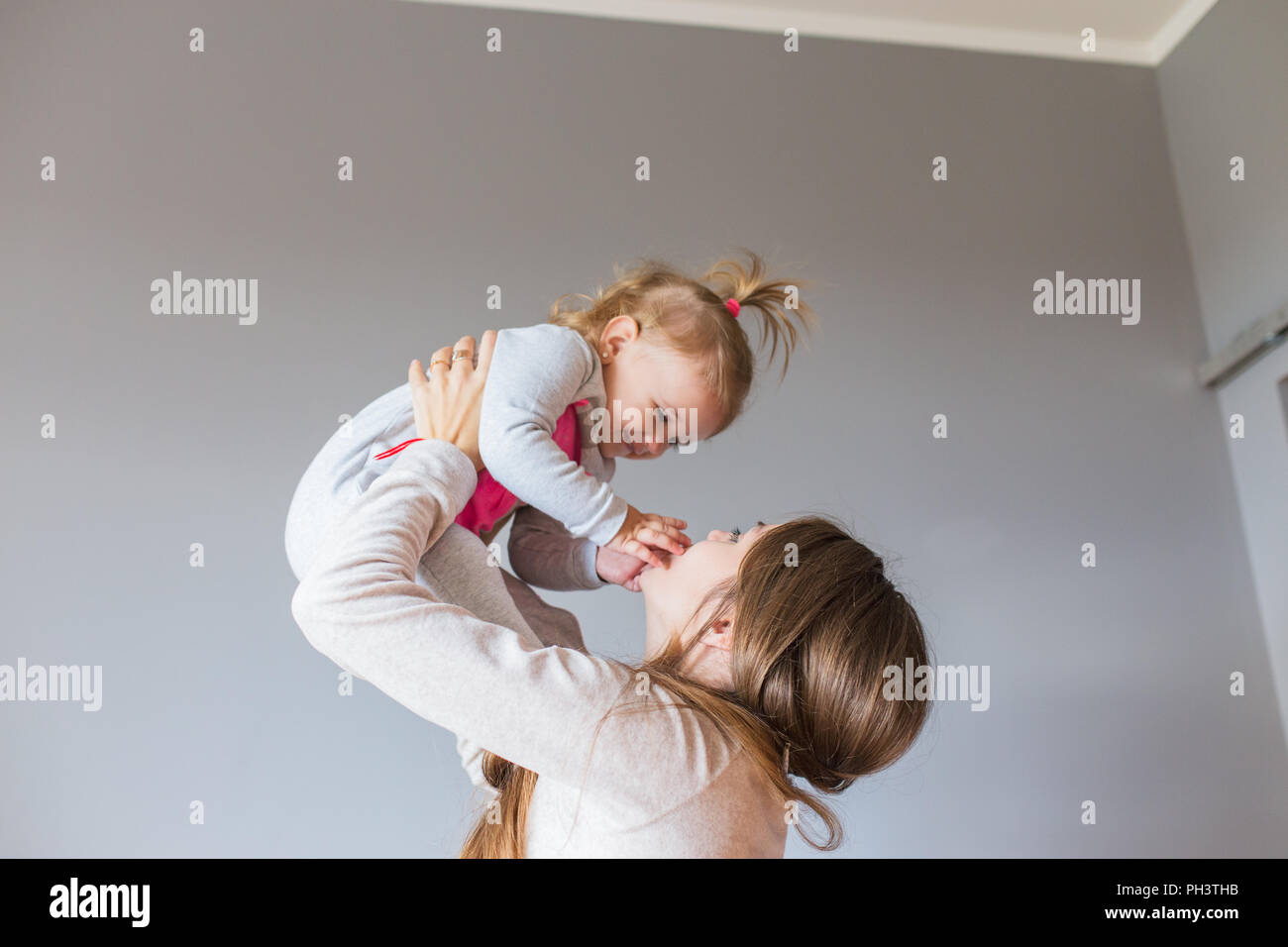 Mom hugging her little daughter. Lifestyle photography, real home Stock Photo - Alamy