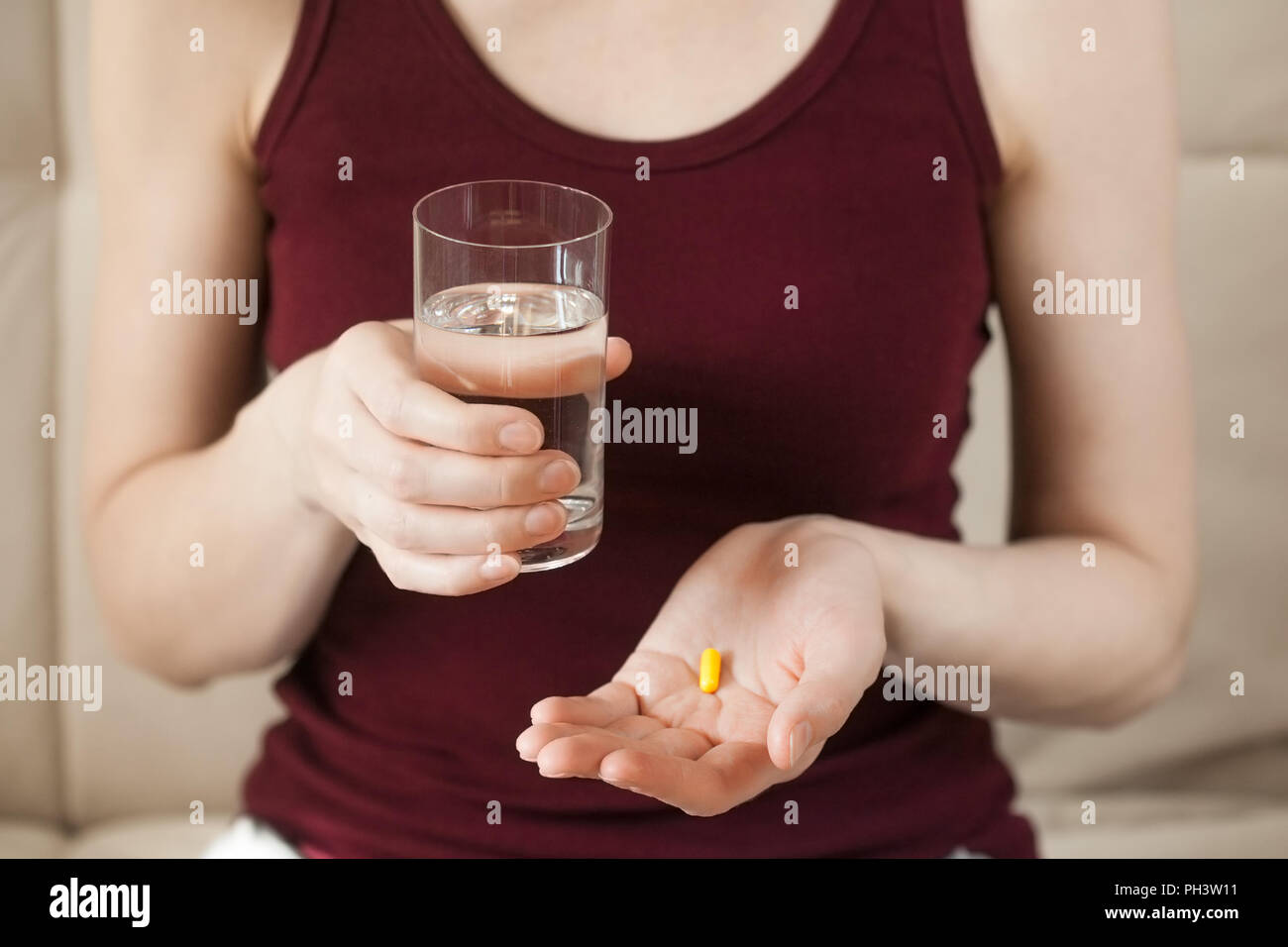 Young woman taking supplements hi-res stock photography and images - Alamy