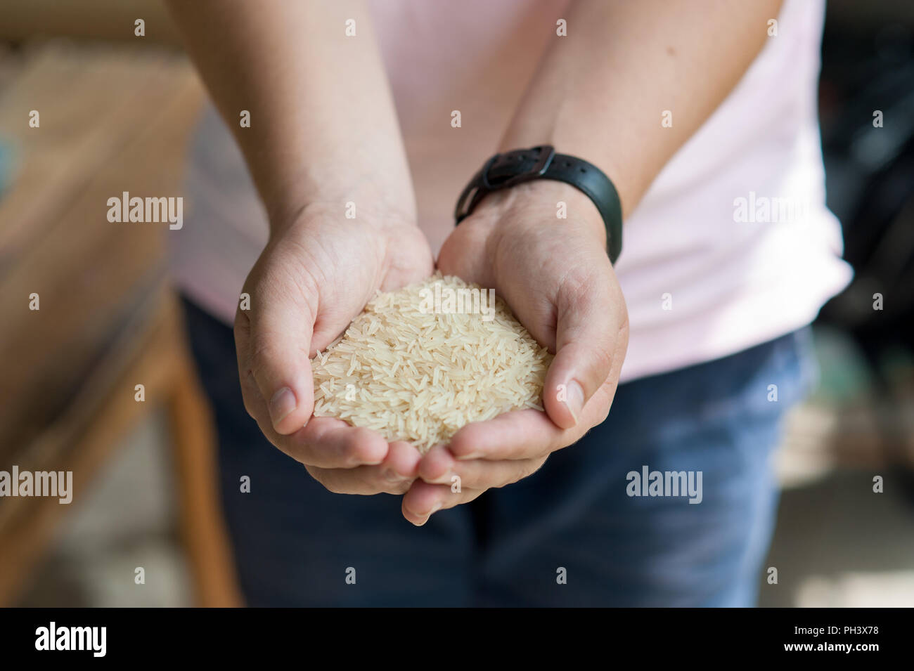 Man hold one portion basmati long rice in palms Stock Photo - Alamy