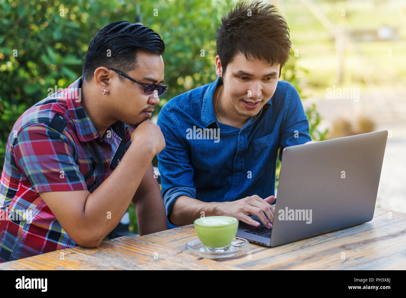 Two men working together on a project hi-res stock photography and ...