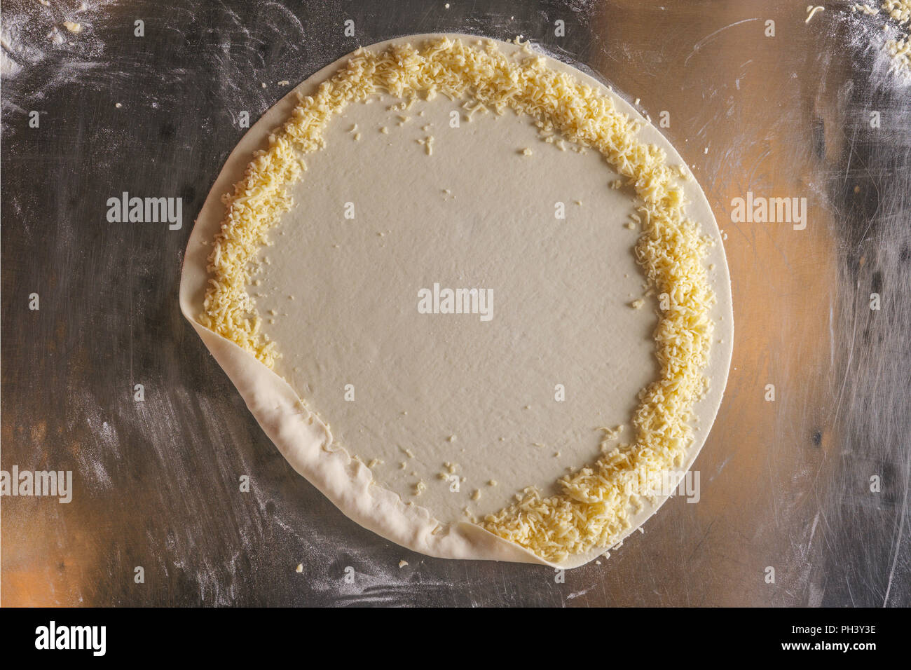 Making cheese border of pizza. Top view of filling Stock Photo - Alamy