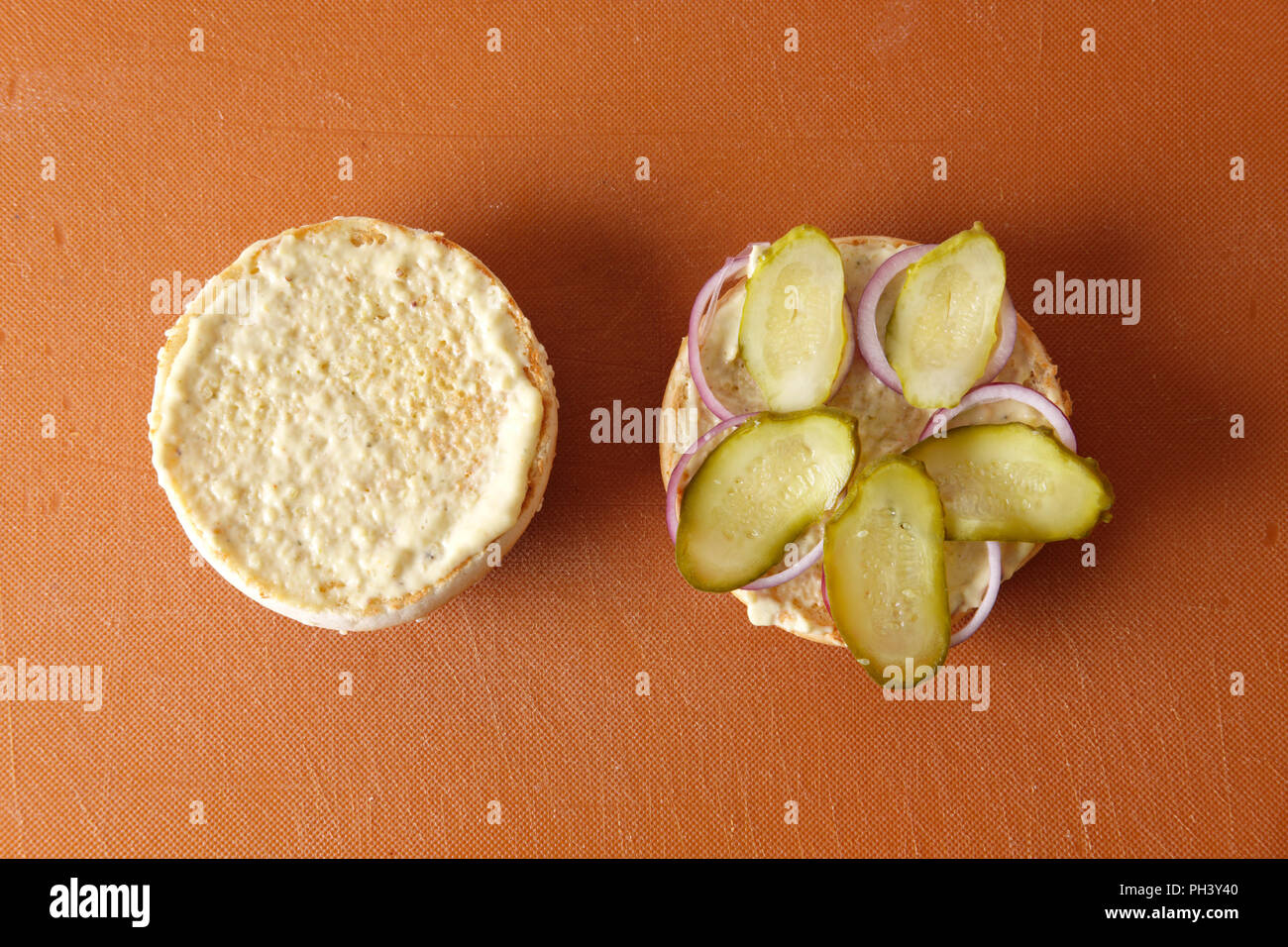 Making burger. Putting ingredients on bun Stock Photo - Alamy