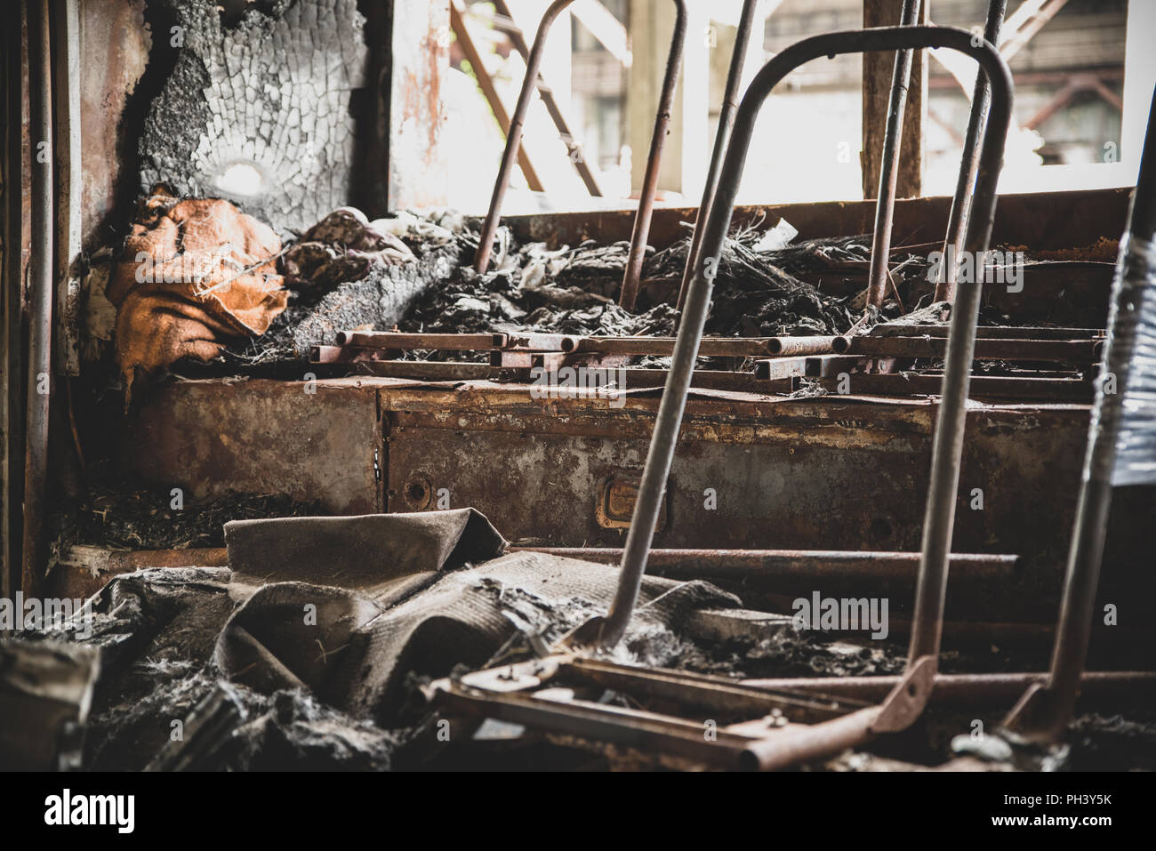 After fire, consequences. Scorched passenger seats in back of the bus ...