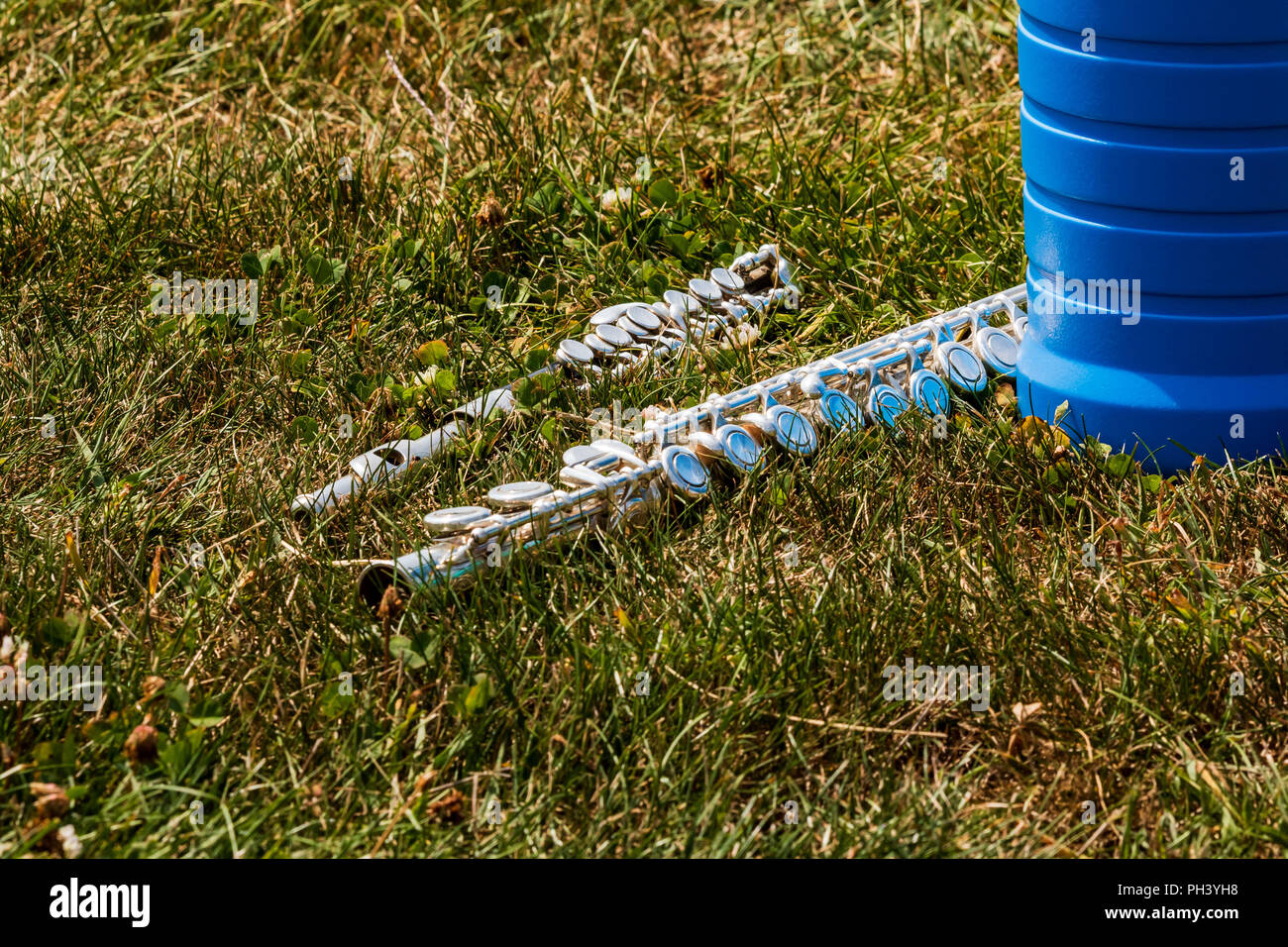 a flute lying in the grass during marching band camp Stock Photo - Alamy