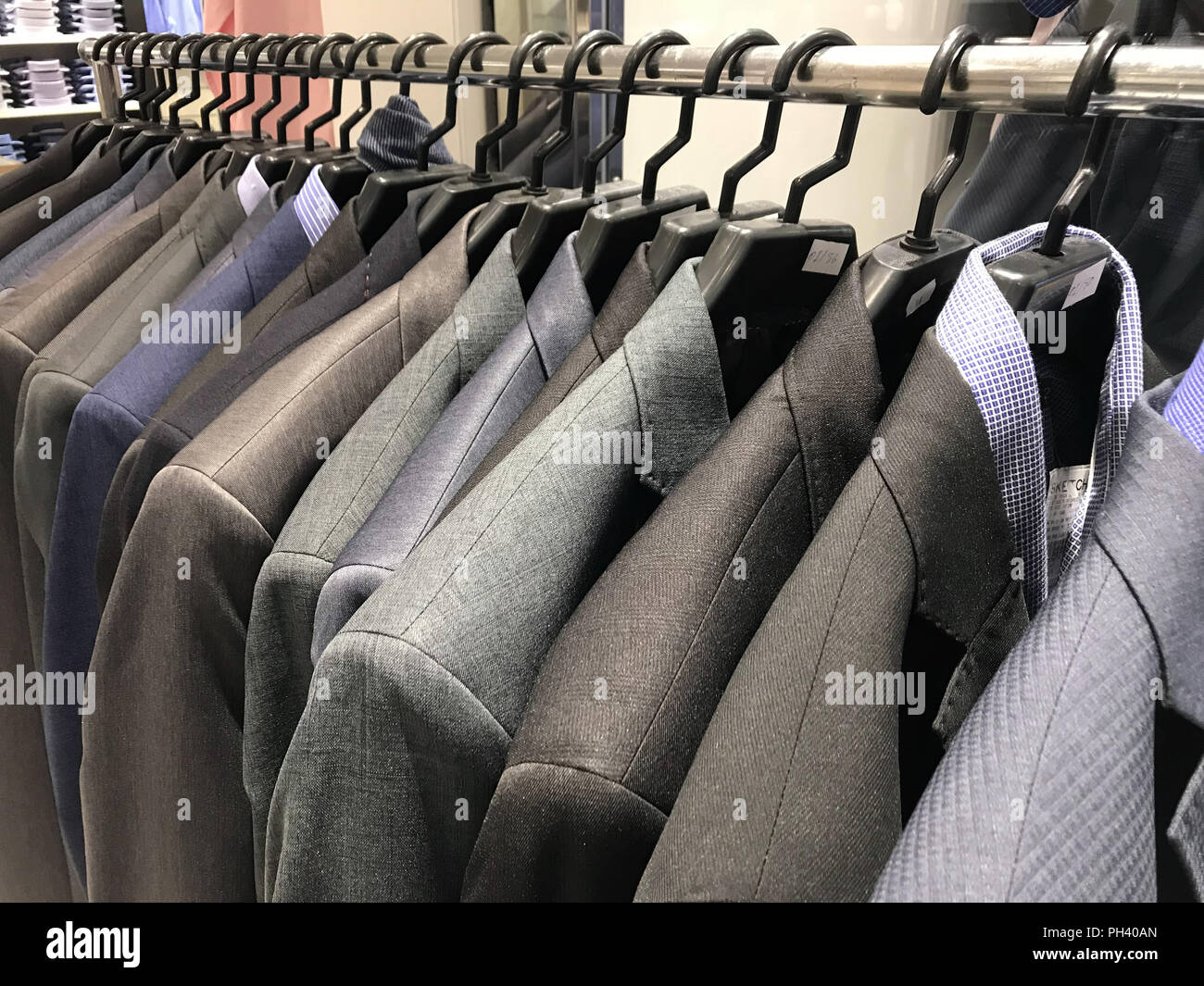 Suits hanging rack hi-res stock photography and images - Alamy