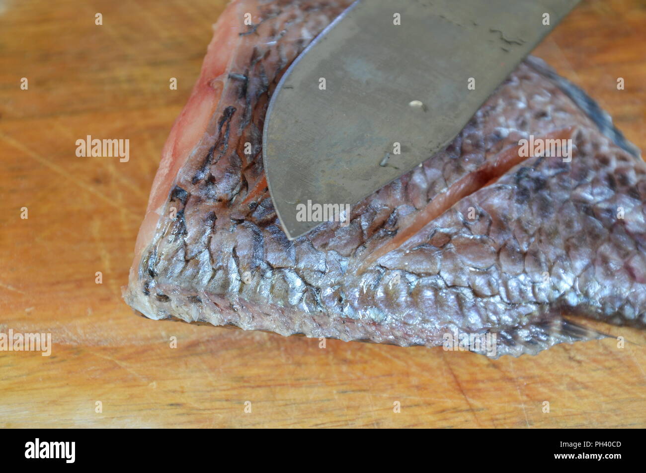 freshwater fish prepare for cook on wooden chop block Stock Photo - Alamy