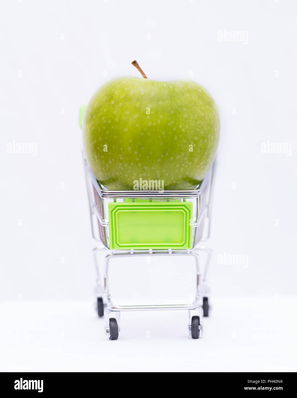 Green apple in toy cart on white backgrond Stock Photo - Alamy