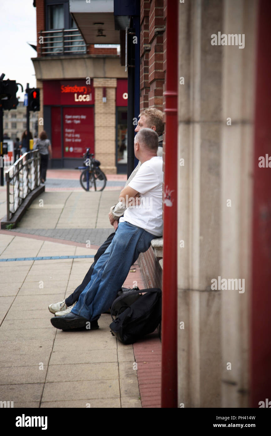 two men lean on wall sheffield city centre division street Stock Photo ...