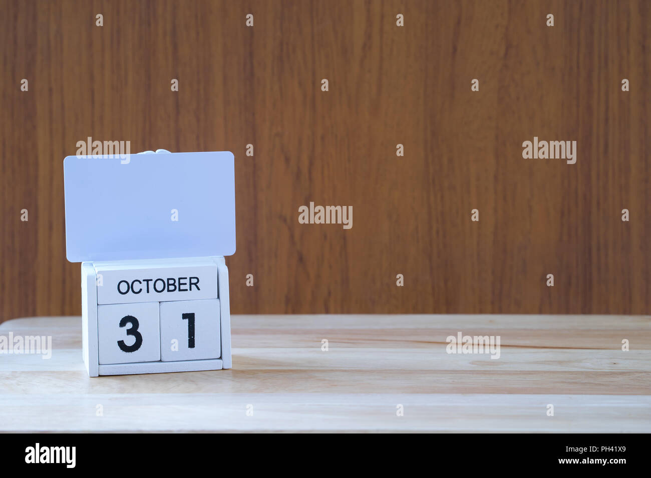 31 October Alphabet on wooden background, white card on blurred pattern ...