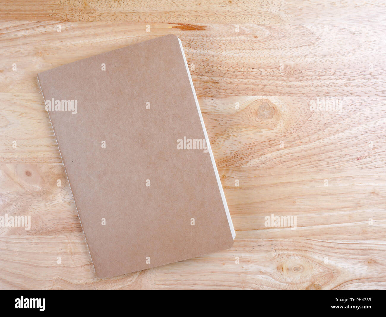 Recycled paper book on wooden background Stock Photo - Alamy