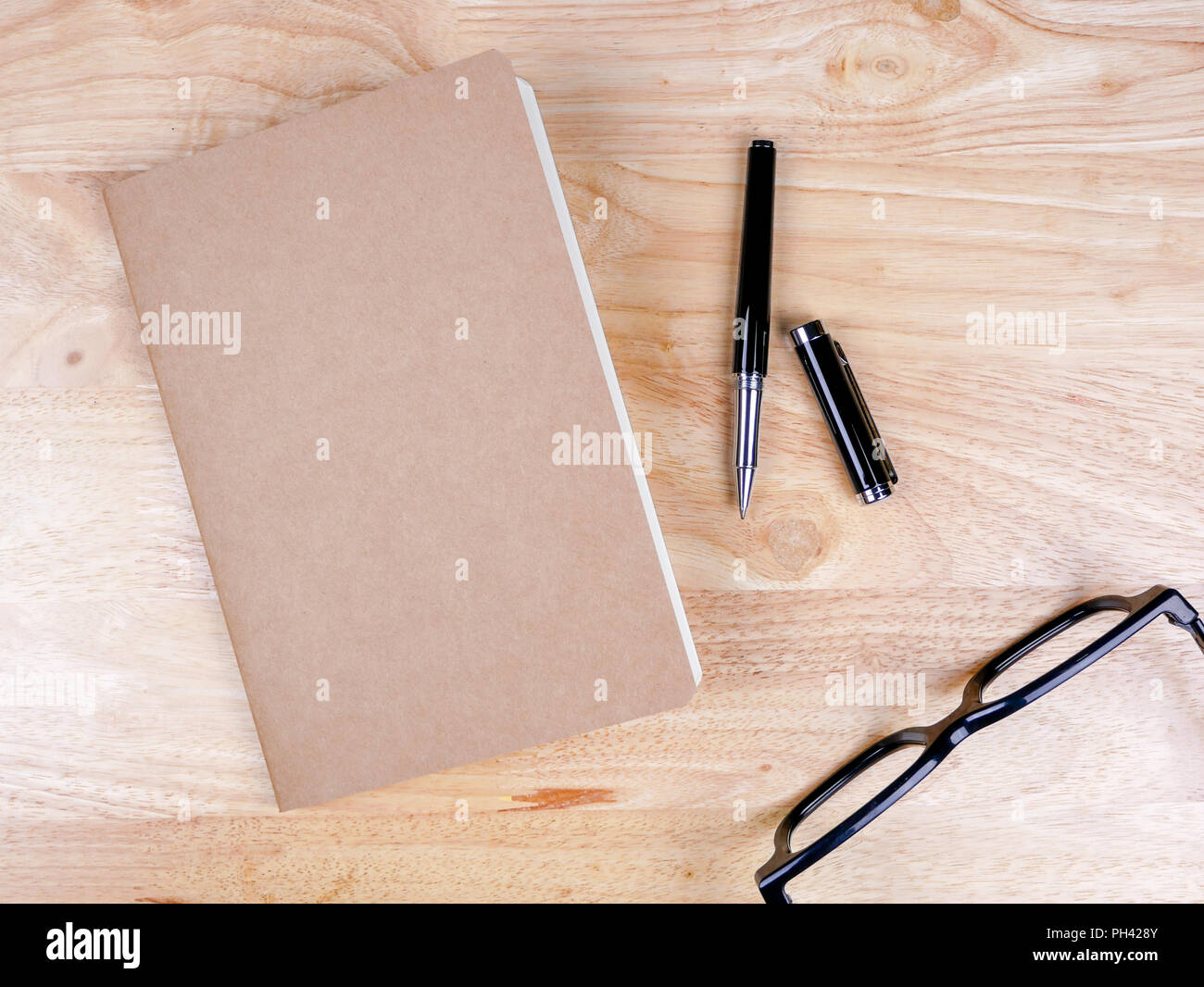 Recycled paper book on wooden background Stock Photo - Alamy