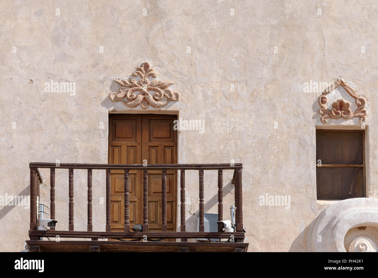 Balcony with railing and window on the front of the Mission San Xavier ...