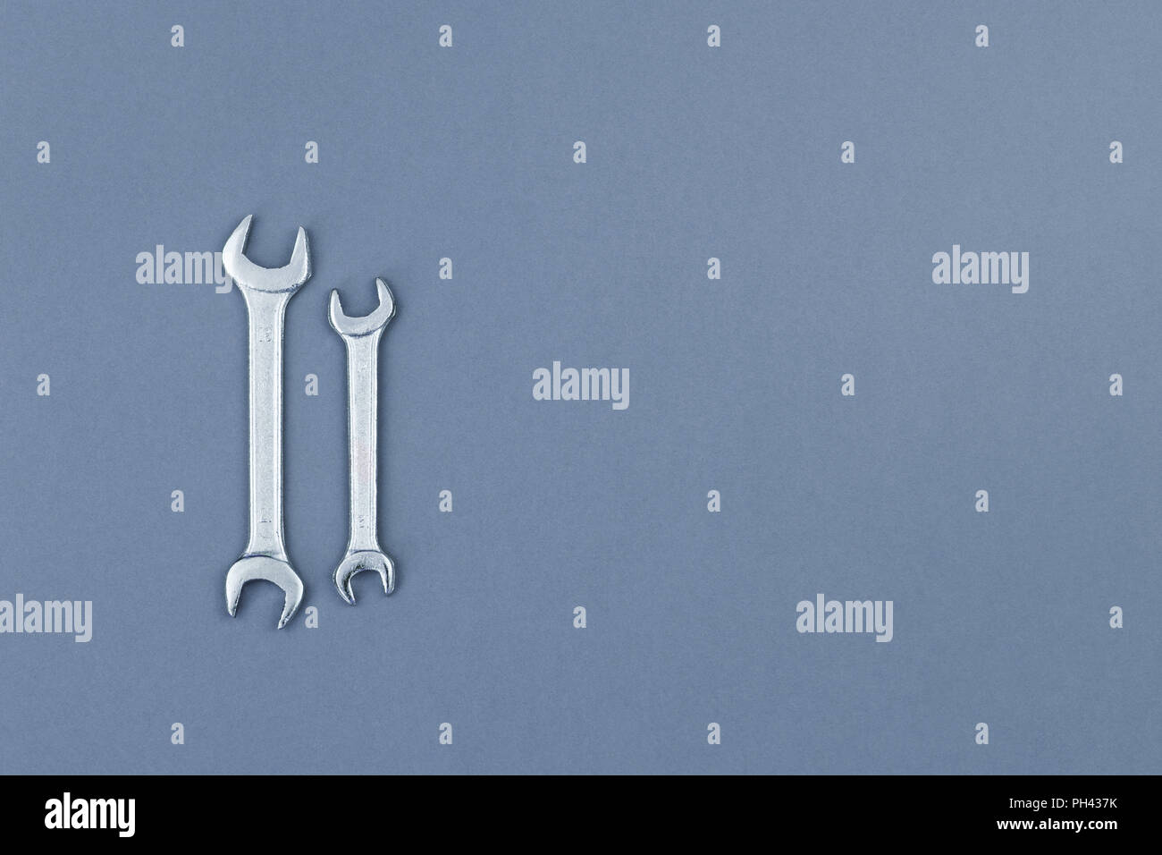 Flat lay of metal spanners on gray background with copy space. Template ...