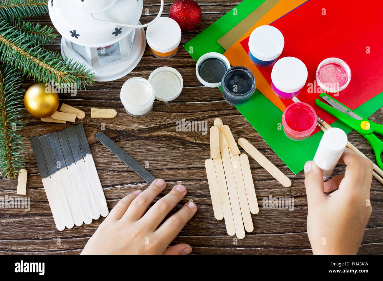 The child glues the parts Christmas decoration or Christmas gift ...