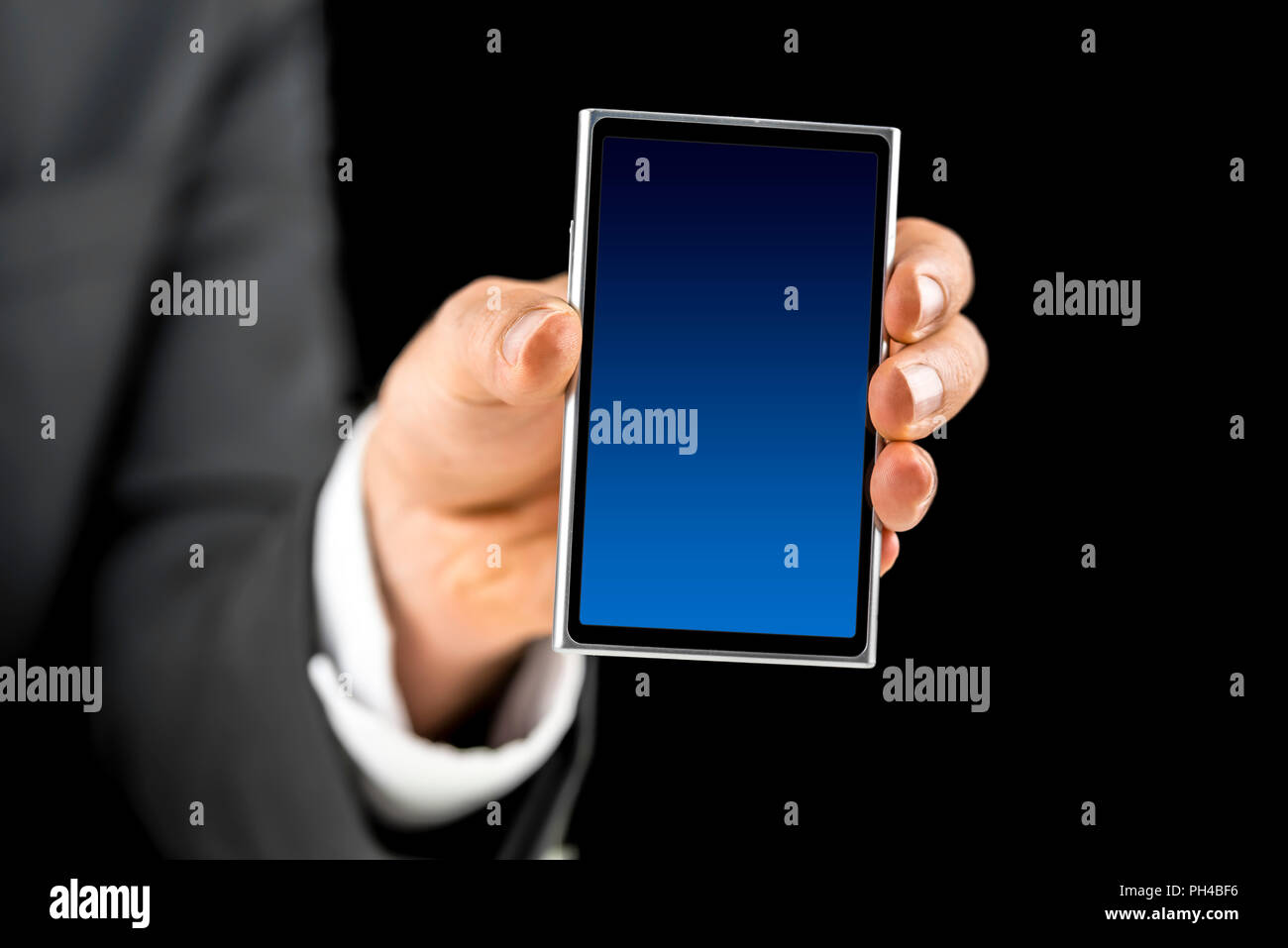 Closeup of businessman holding mobile phone with blue empty screen ...