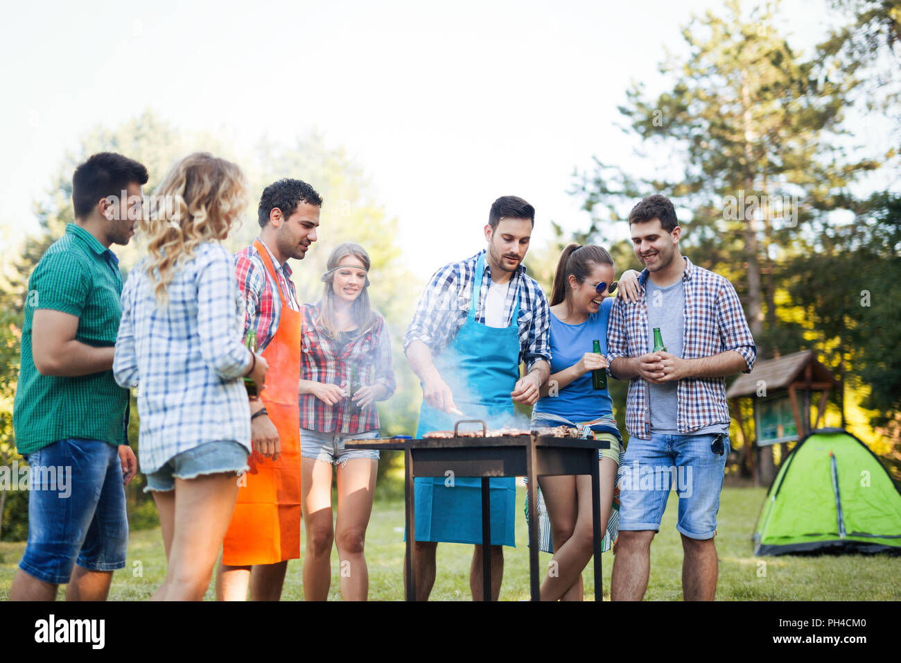 Friends enjoying bbq party Stock Photo - Alamy
