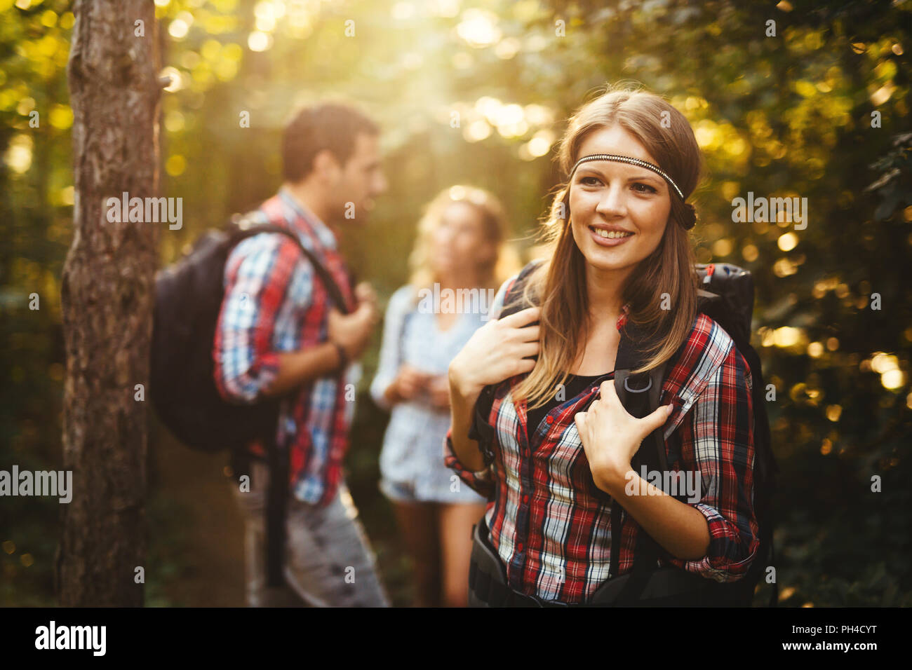 Group of backpacking hikers going for forest trekking Stock Photo - Alamy