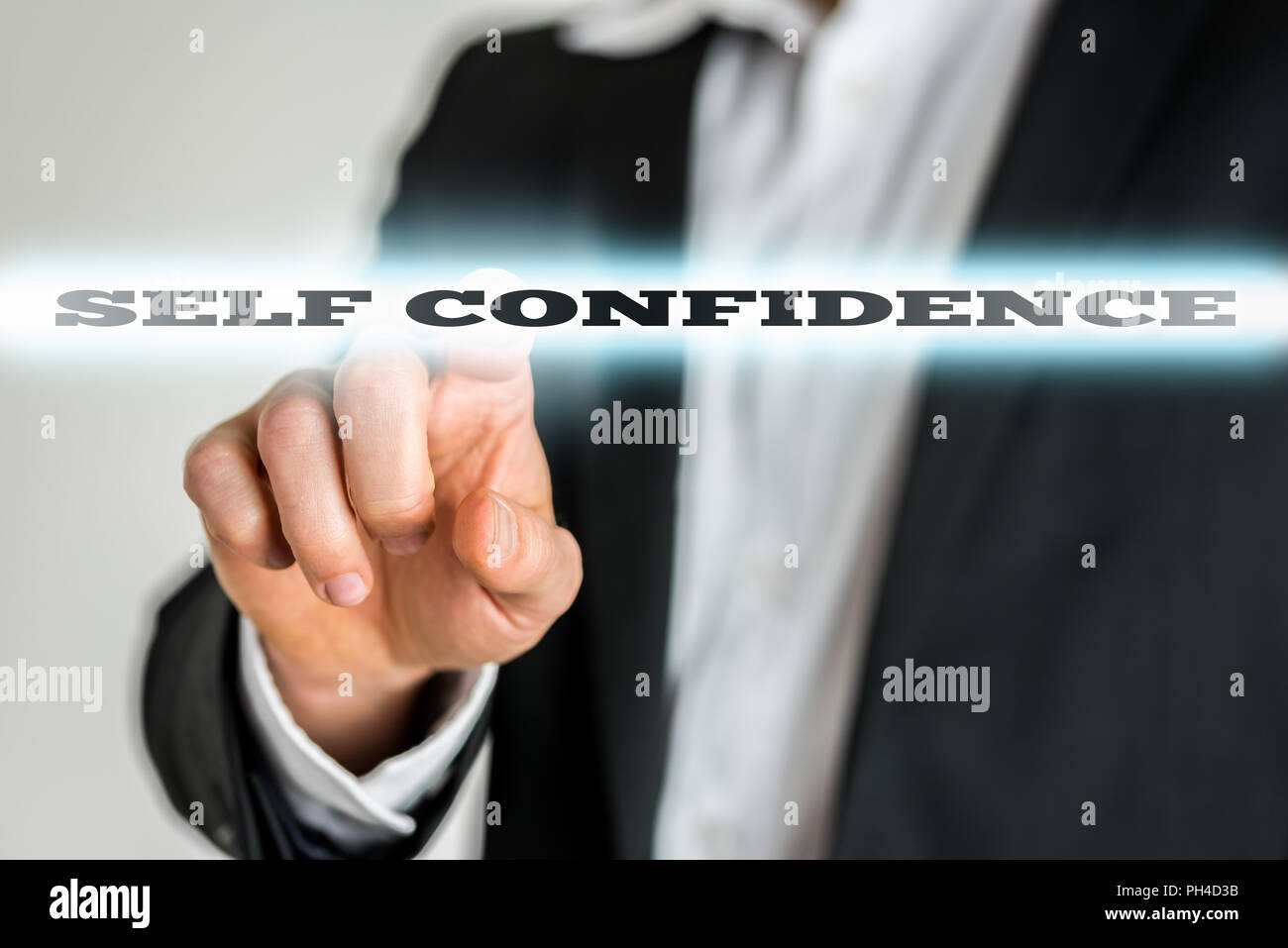 Closeup of businessman activating a Self confidence button on virtual ...