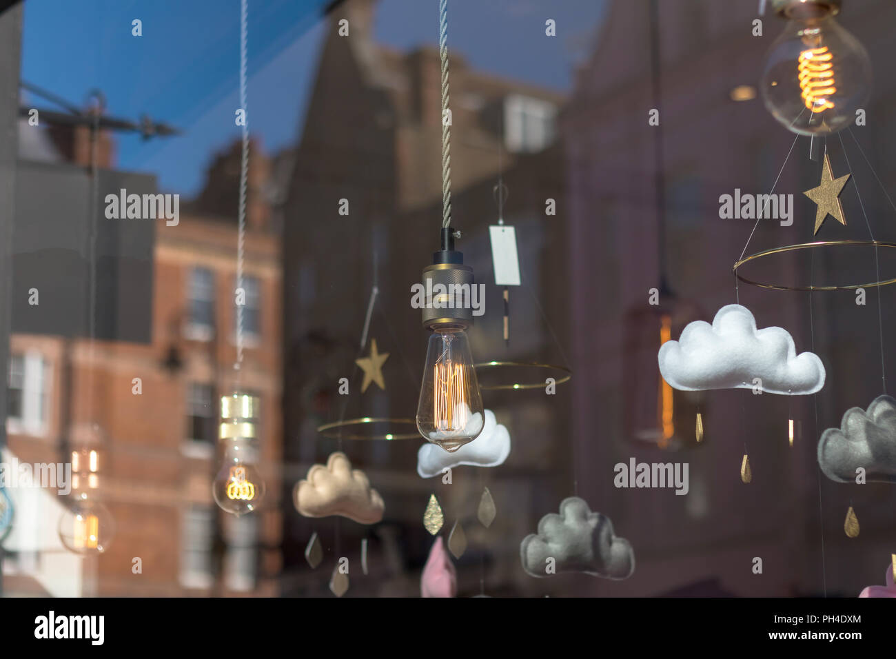 Decorative lights and fabric clouds hanging inside store on display ...