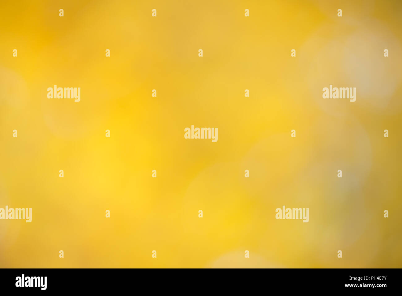 Blurred yellow abstract background with a mottled graduated pattern ...