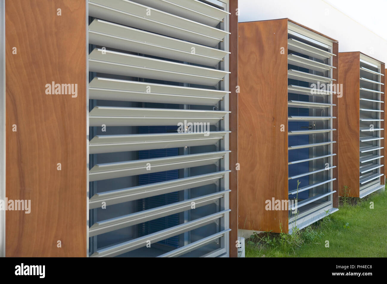 Modern building windows facade in aluminum, glass and wood. Horizontal ...