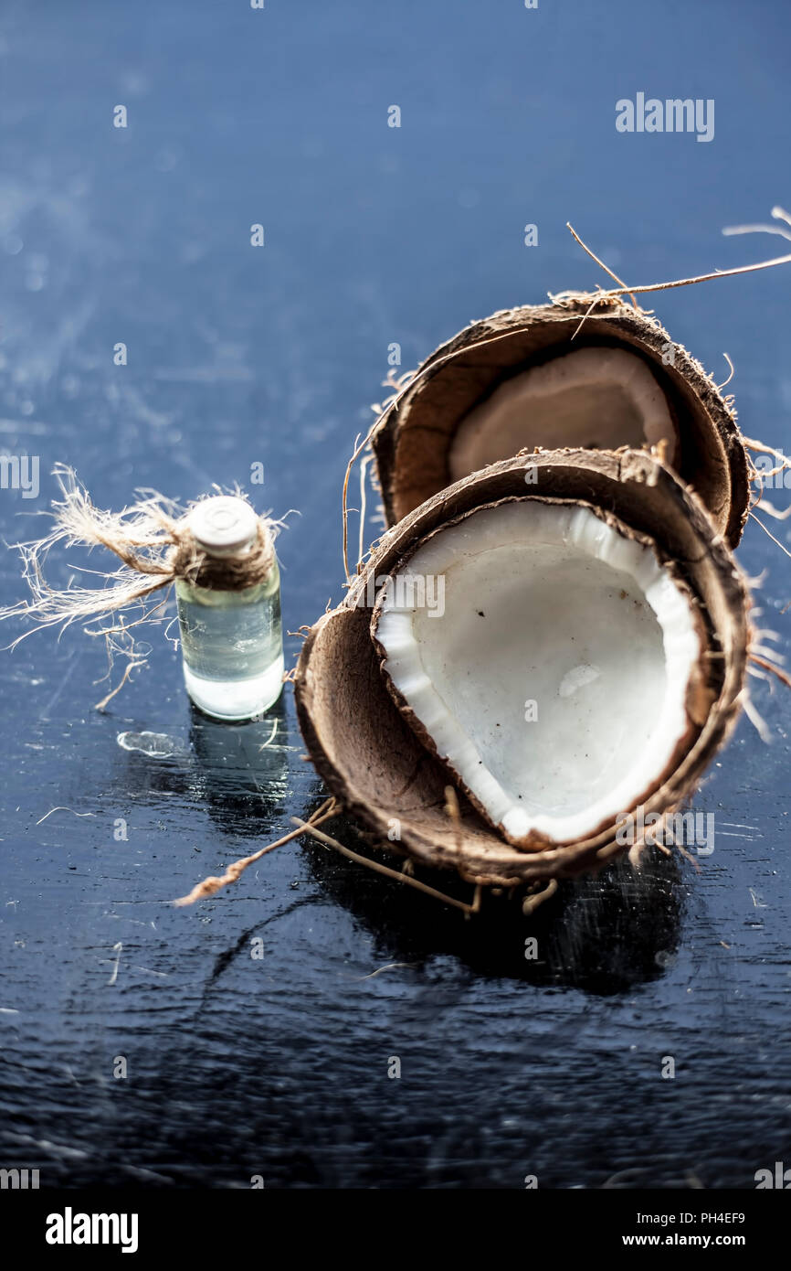Close up of raw organic coconut or Cocos nucifera with its essence in a ...