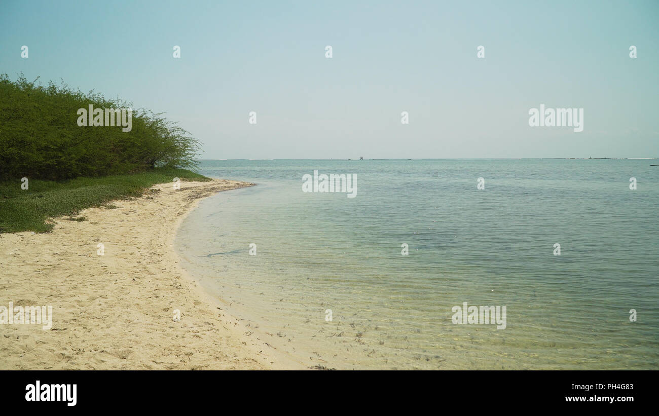 Tropical island with white sandy beach in blue lagoon. Tondol white ...