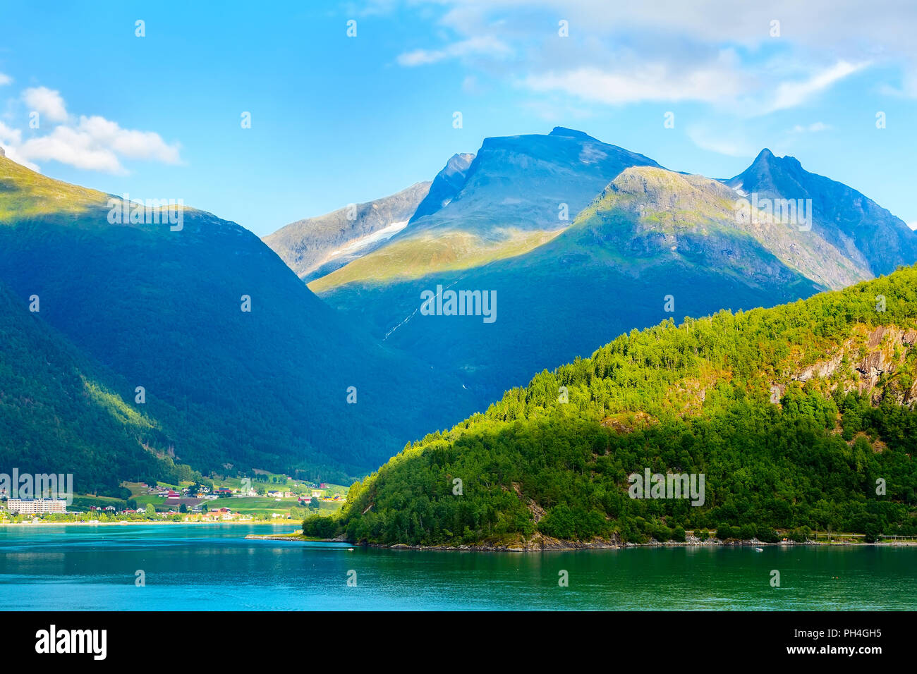 Norwegian village landscape with fjord, high mountains and colorful ...