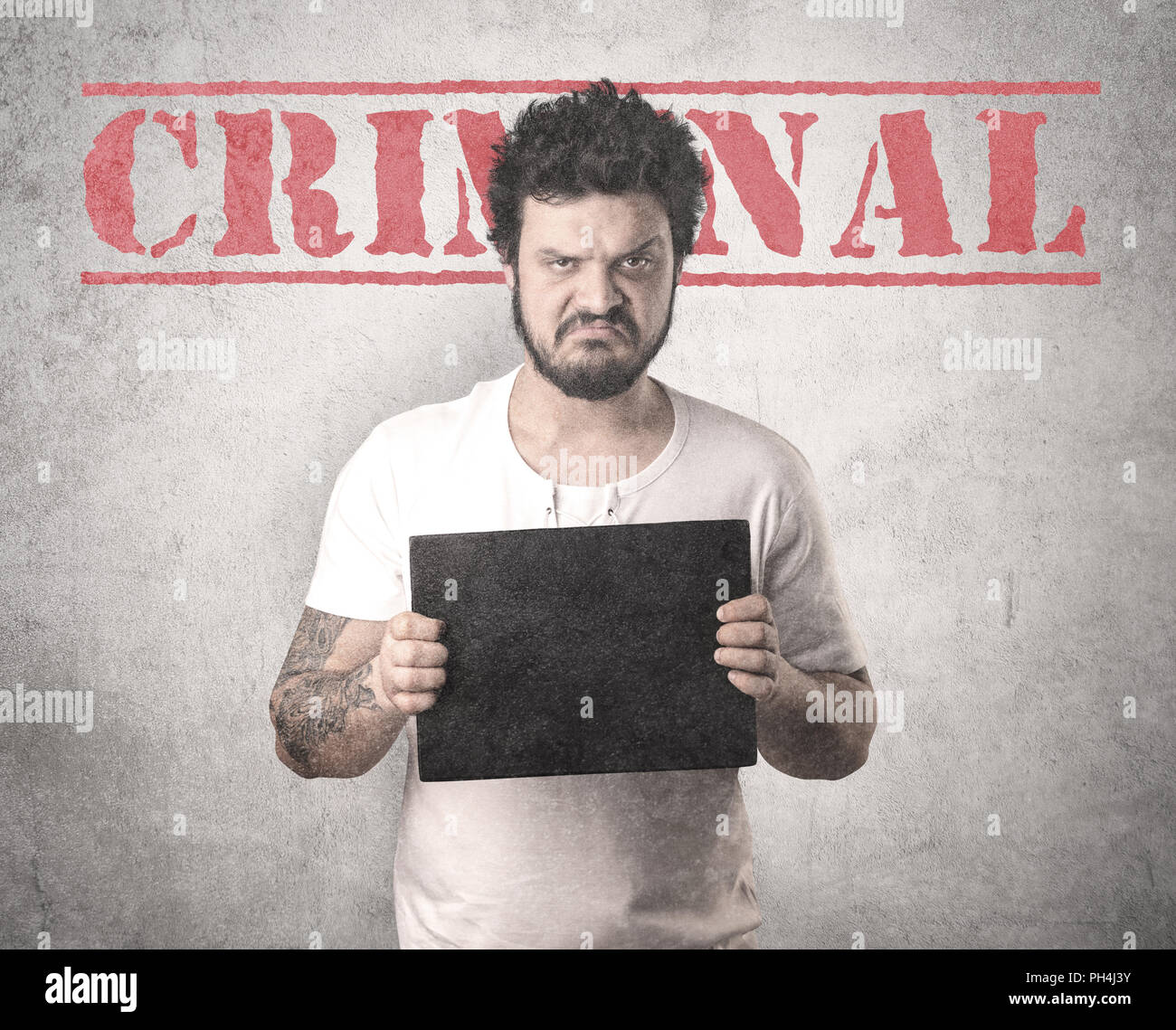 Caught gangster with criminal background Stock Photo - Alamy