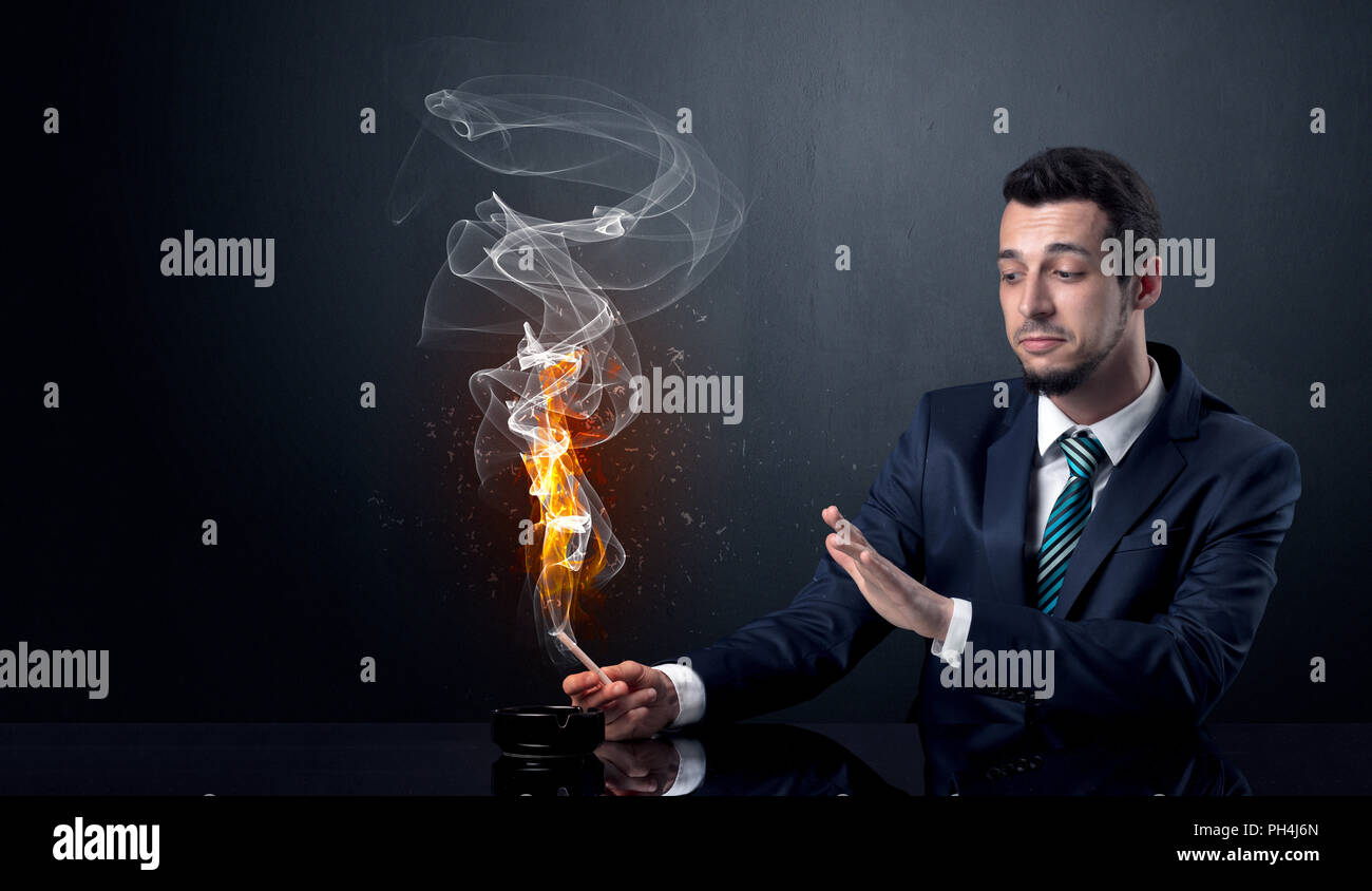 Businessman smoking with inferno effect Stock Photo - Alamy
