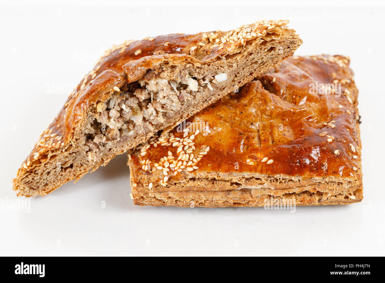 Tasty pastry of rye dough cut in half . Delicious pastries with minced ...