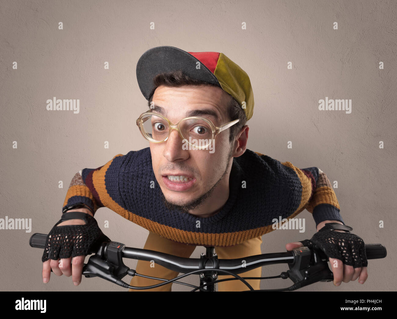 Nerd young foolish biker on a bike with oldschool outfit Stock Photo ...