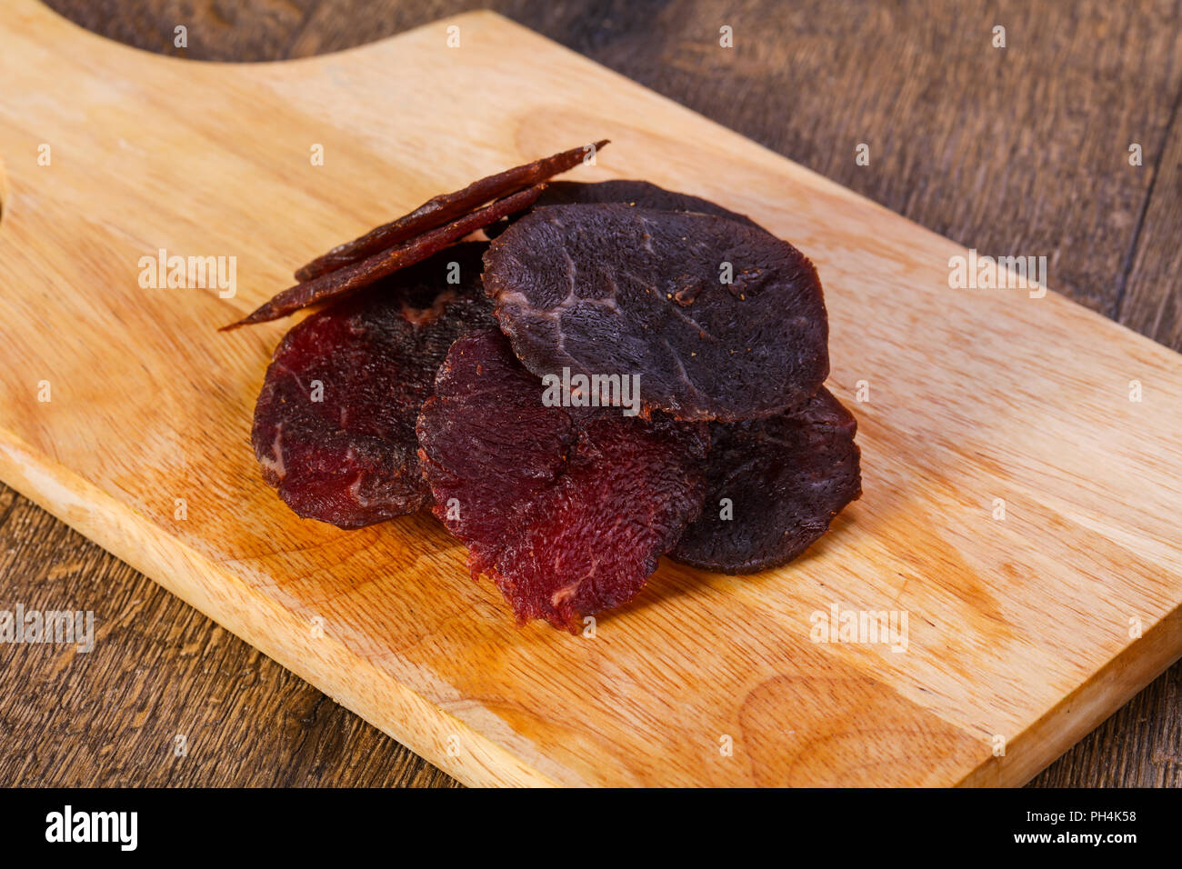 Dry beef meat over wooden Stock Photo - Alamy