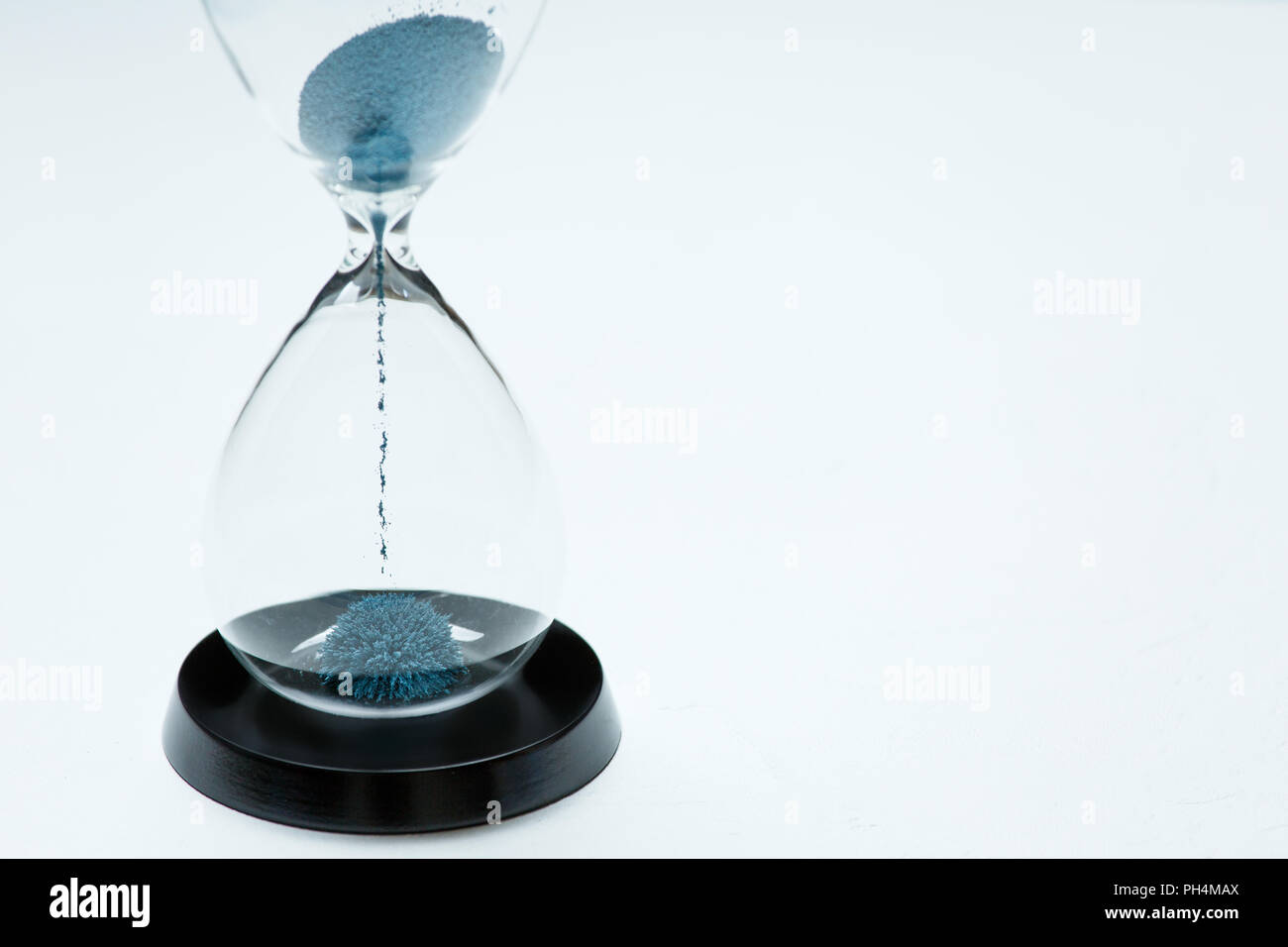 Photo of hourglass with blue sand on isolated white background Stock ...