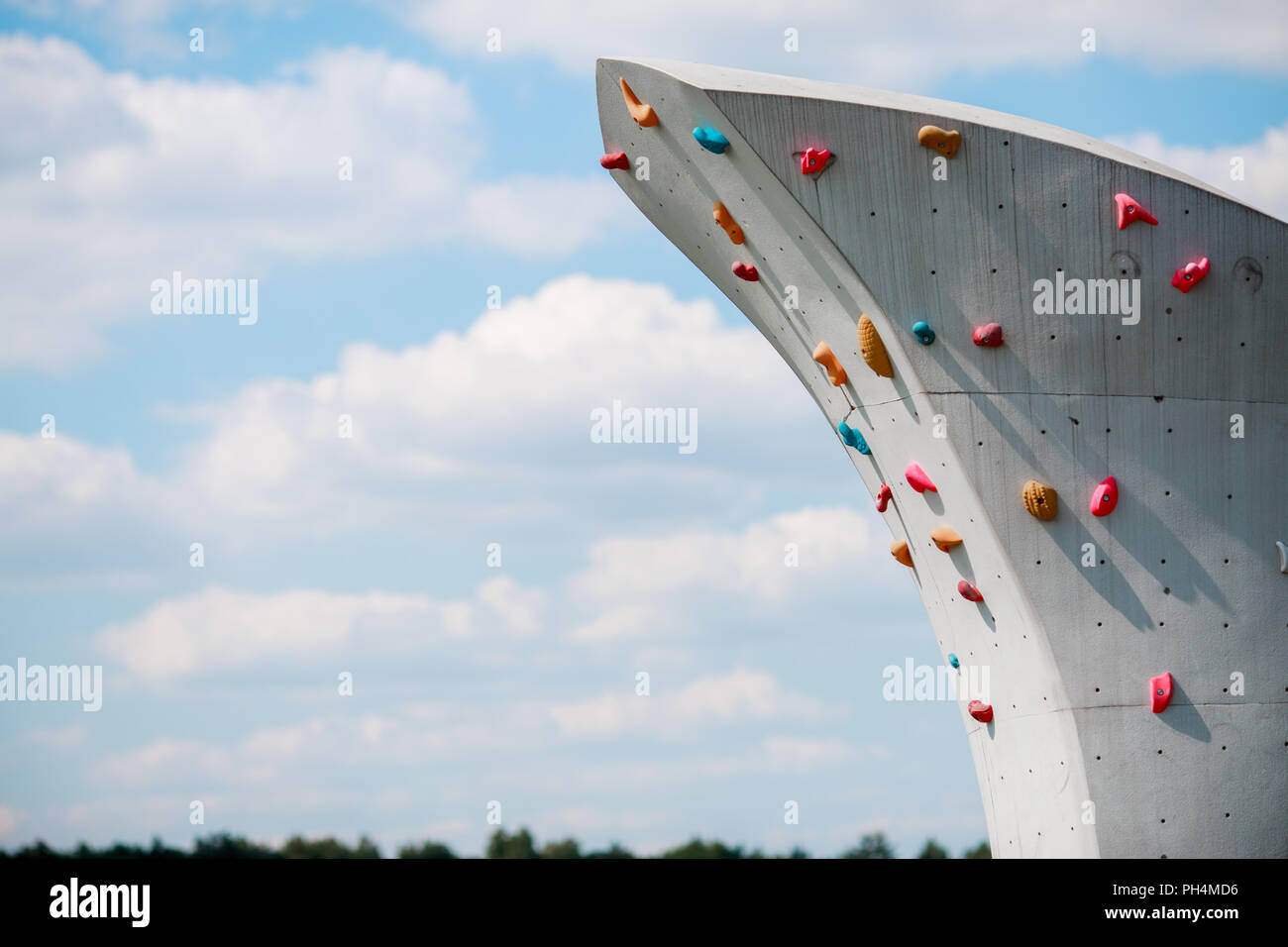 Photo of wall for rock climbing against blue sky with clouds Stock ...