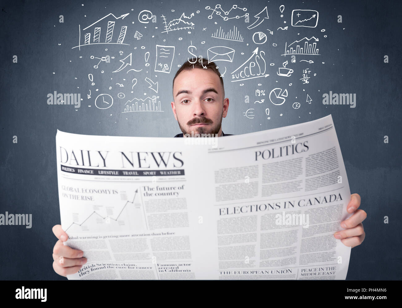 Young smart businessman reading daily newspaper with business plan ...