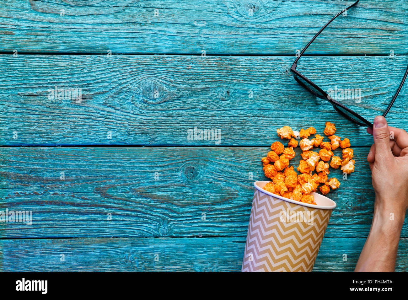 People eating popcorn. Human hands. Top view Stock Photo - Alamy