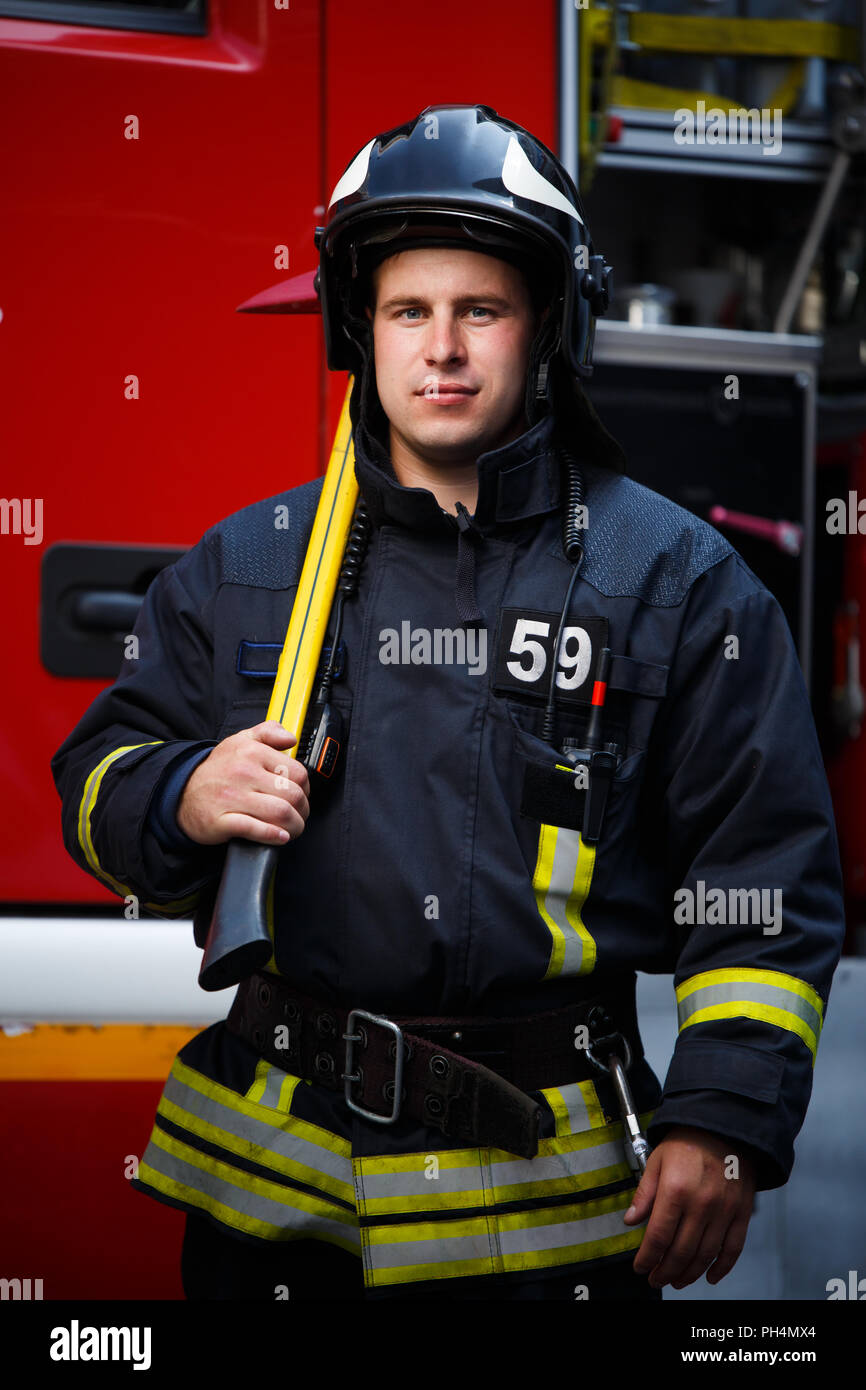 Fireman holding water hose hi-res stock photography and images - Alamy
