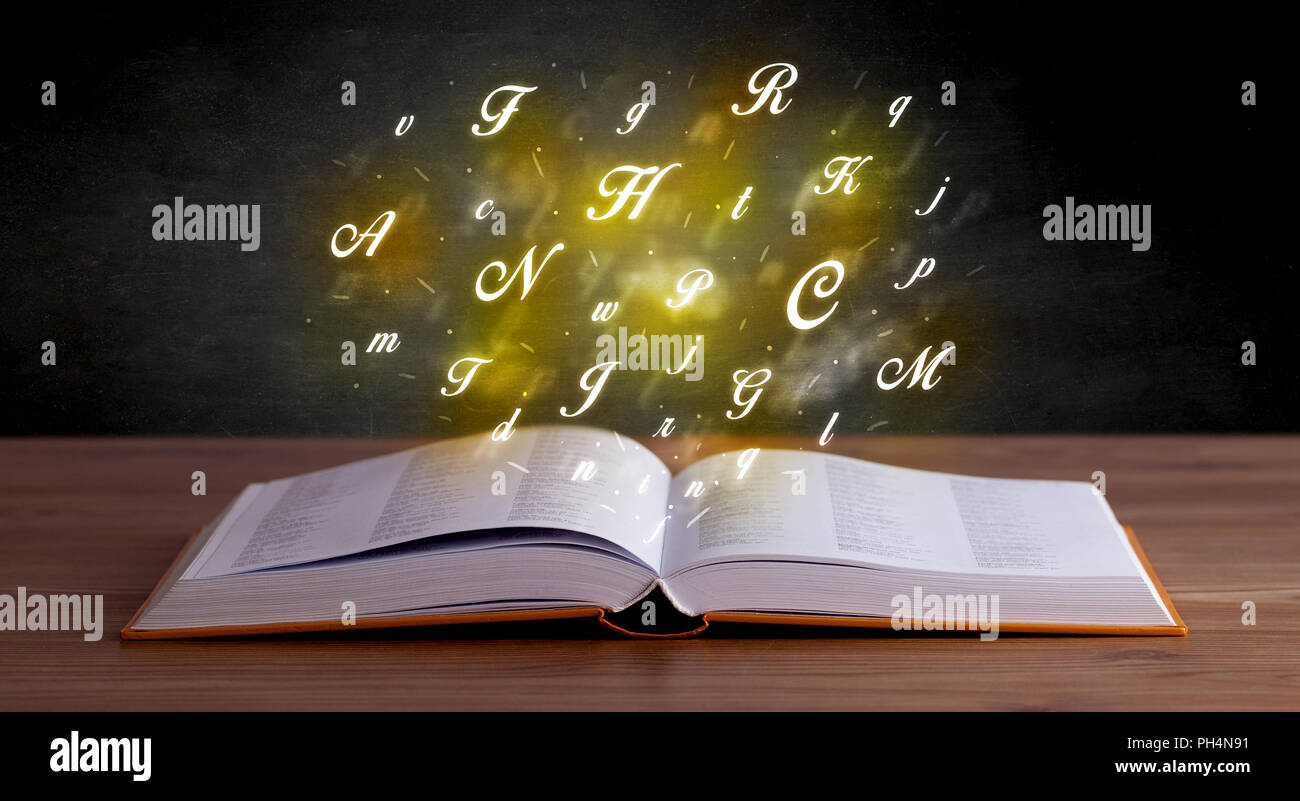 Glowing yellow alphabet letters coming out of an open book Stock Photo ...