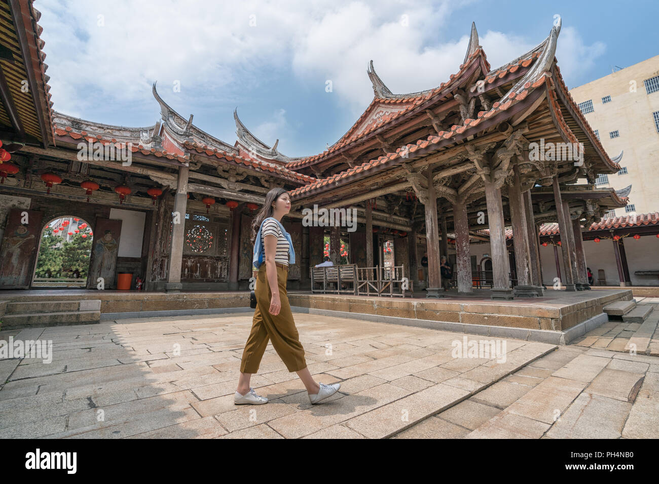 walking around the temple. side view of a asian woman Stock Photo - Alamy