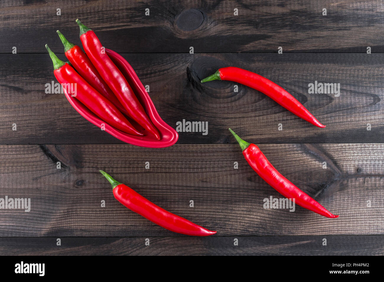 chilli peppers on wooden background Stock Photo - Alamy