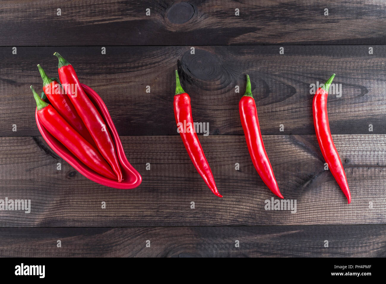 chilli peppers on wooden background Stock Photo - Alamy