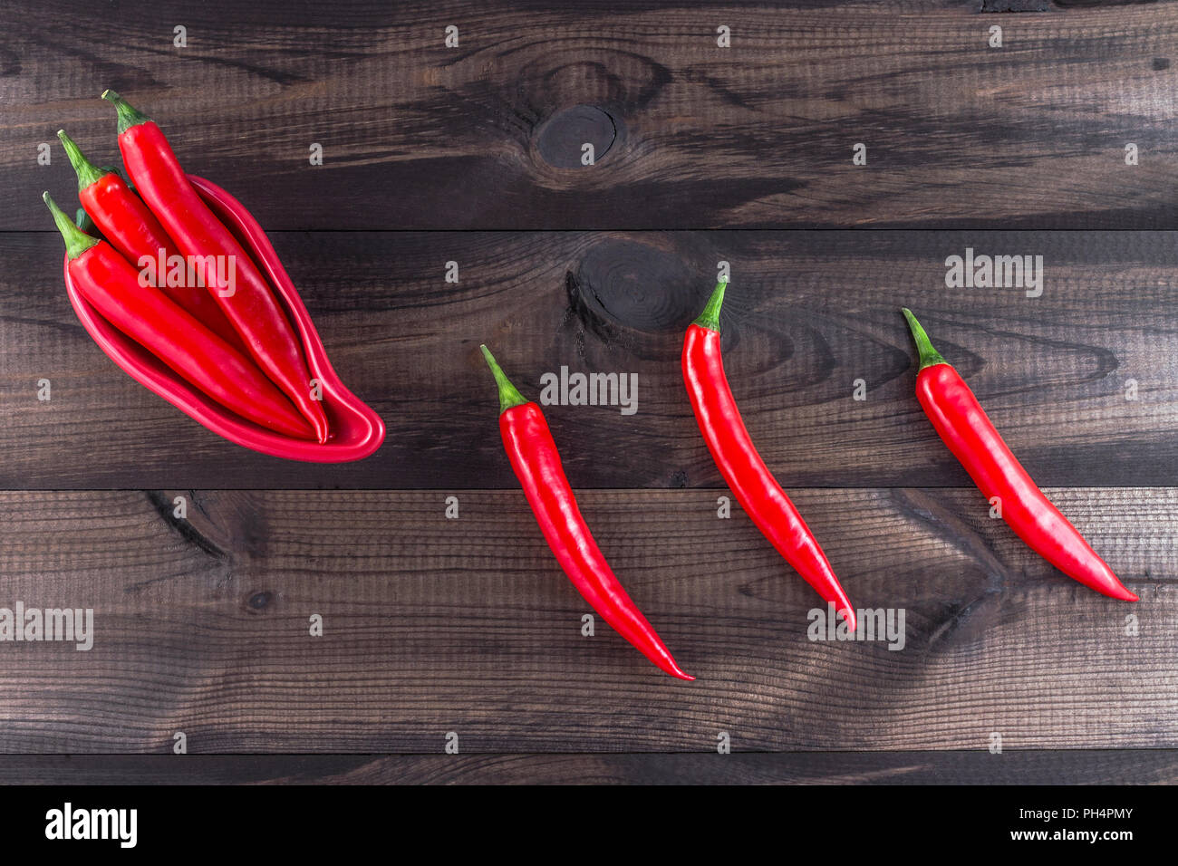 chilli peppers on wooden background Stock Photo - Alamy