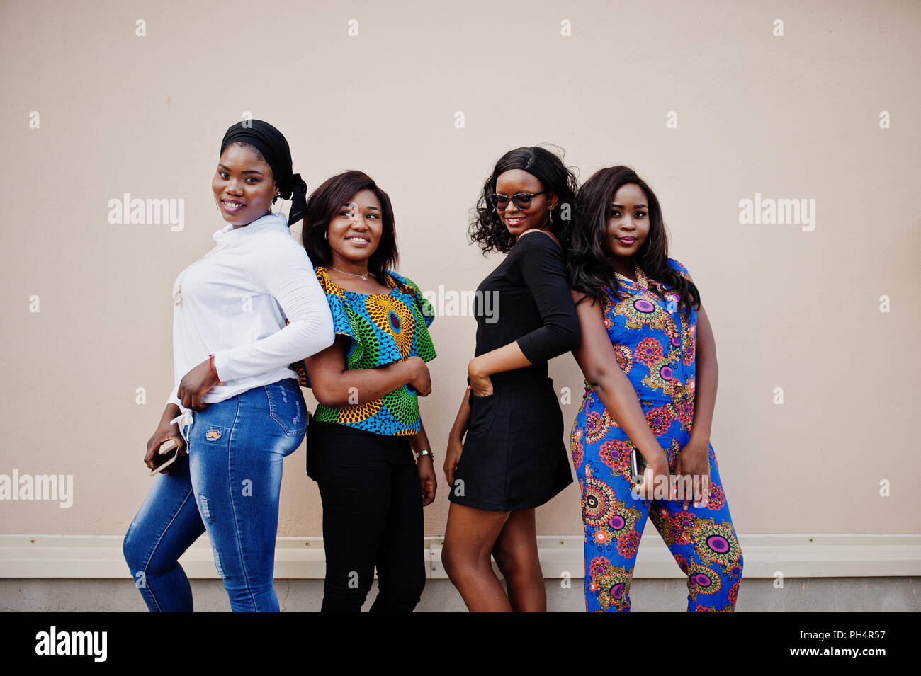 Group of four african american girls posed outdoor against wall Stock ...